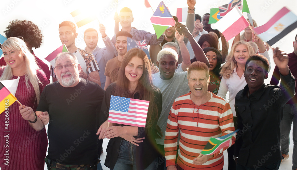 group of people with their national flags walking together . Stock ...