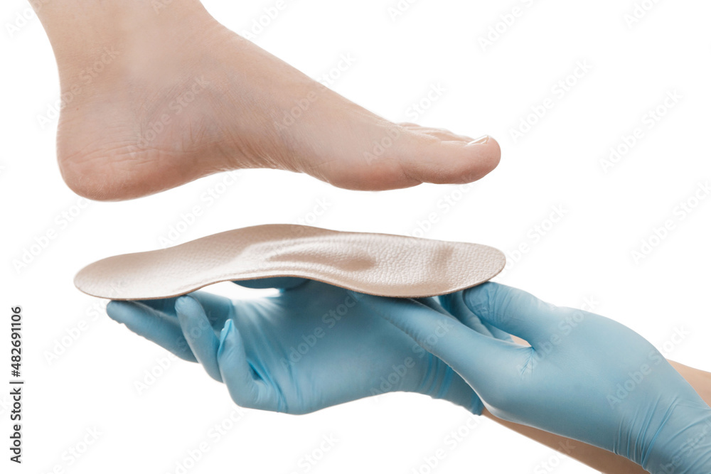 Orthopedic insole isolated on a white background. Hands in rubber ...
