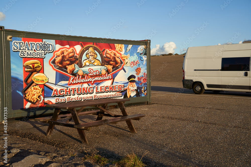 Fast food snack bar on road in front of a dam. Container building of ...