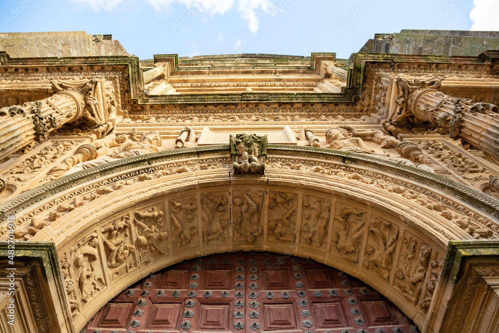 Fragment of the facade of the ancient arch with bas-reliefs and columns ...