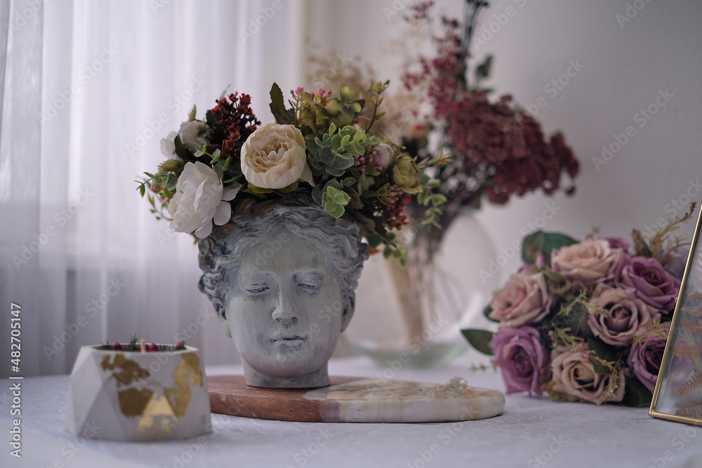 table by the window with interior details antique bust of Venus with ...