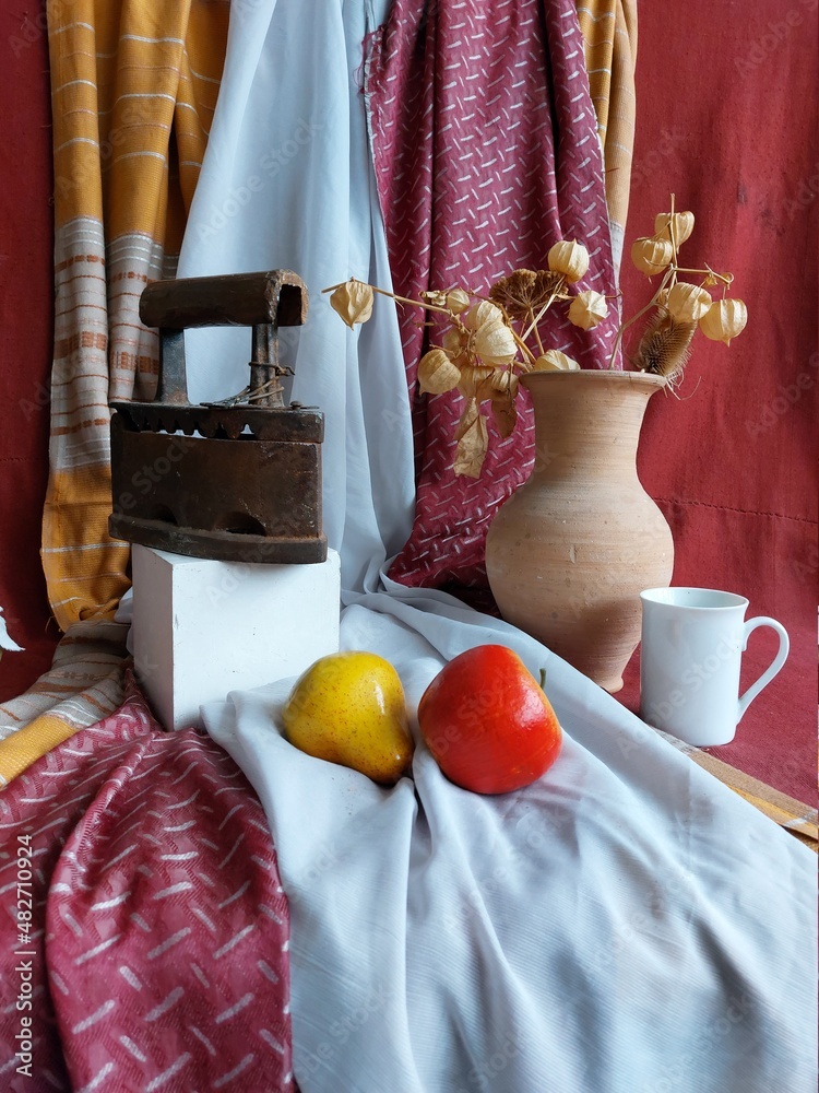 A colorful still life of household items: a ceramic vase, an antique ...