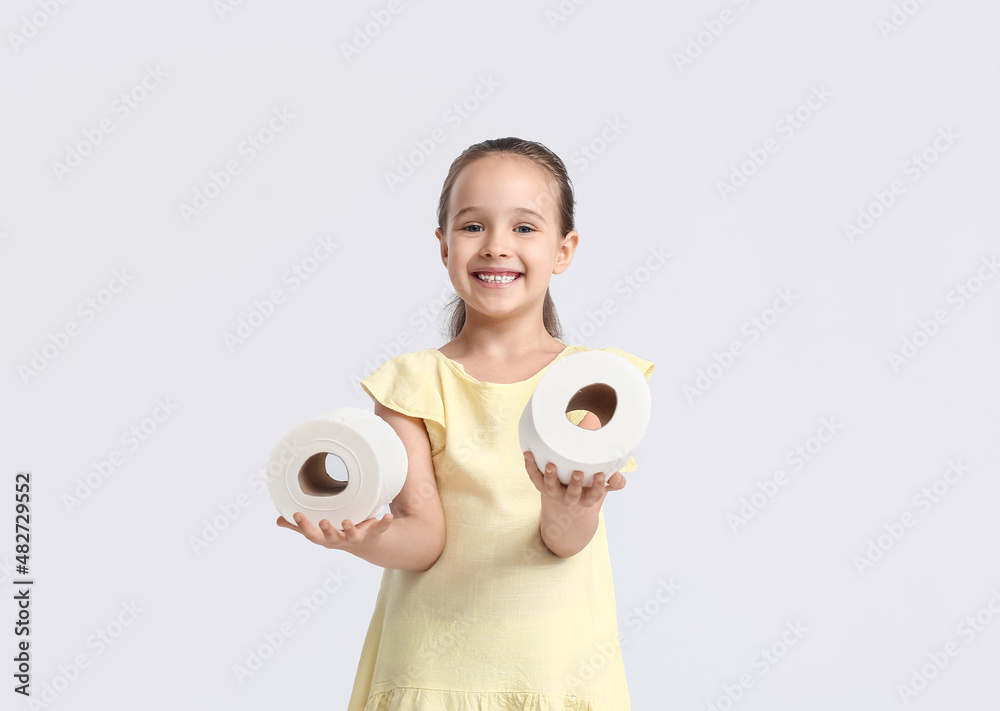 Funny little girl with rolls of toilet paper on light background Stock ...
