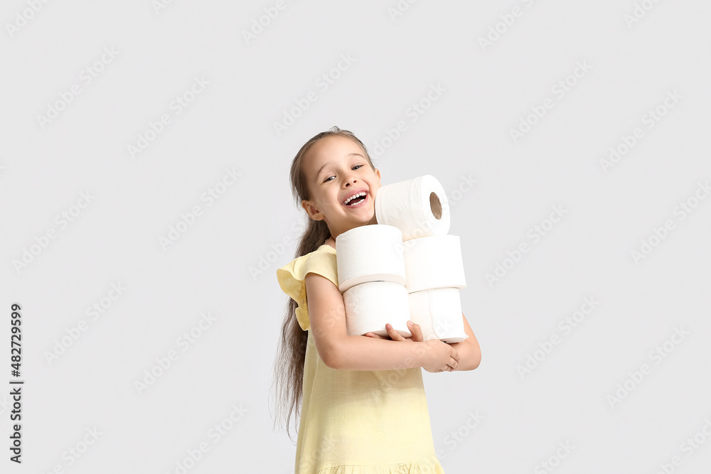 Cute little girl with rolls of toilet paper on light background Stock ...