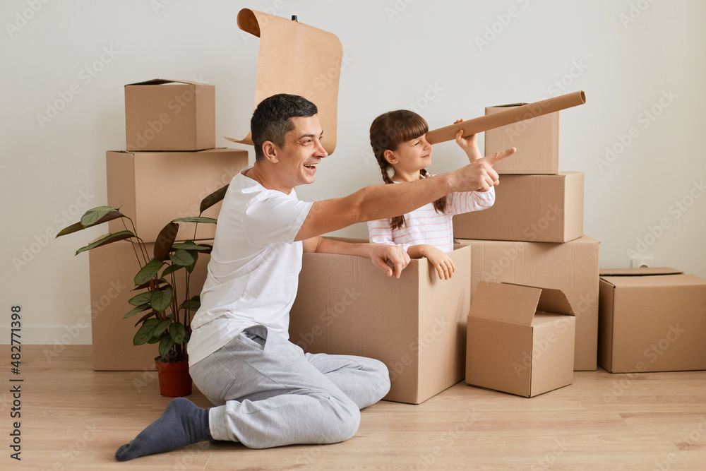 Portrait of little girl making ship with flag during relocation and ...