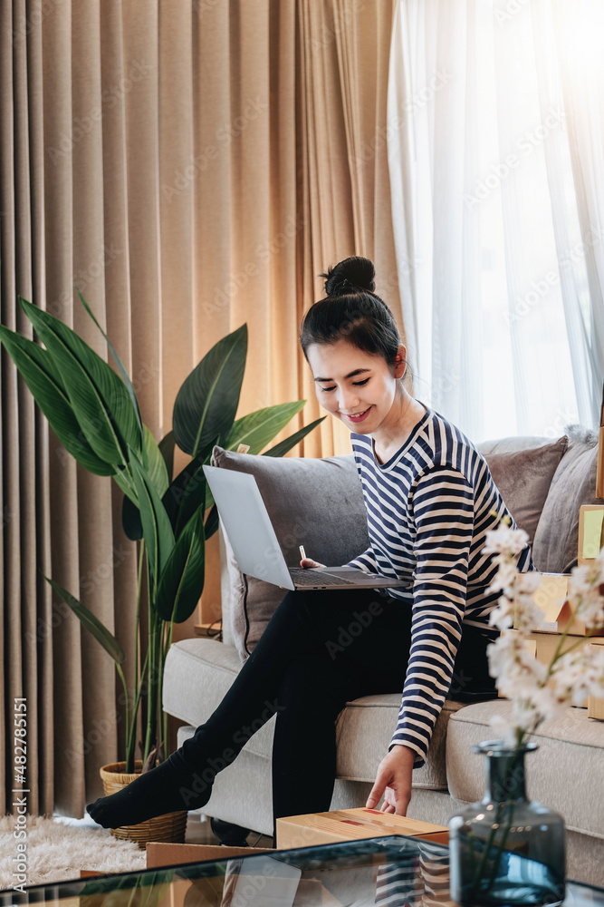 Online merchandising business idea, a beautiful girl is using a ...