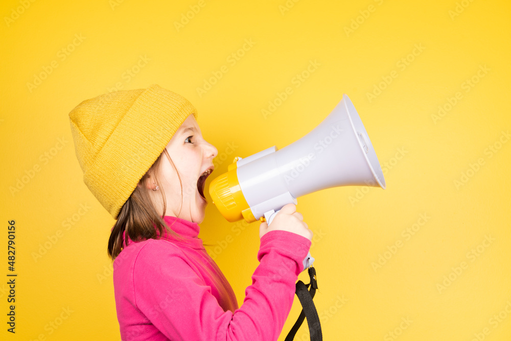 Angry little girl shouting loud on loudspeaker. Children rights concept ...