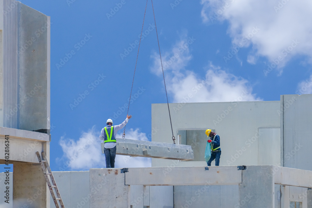 Construction worker are installing the precast concrete beam at housing ...