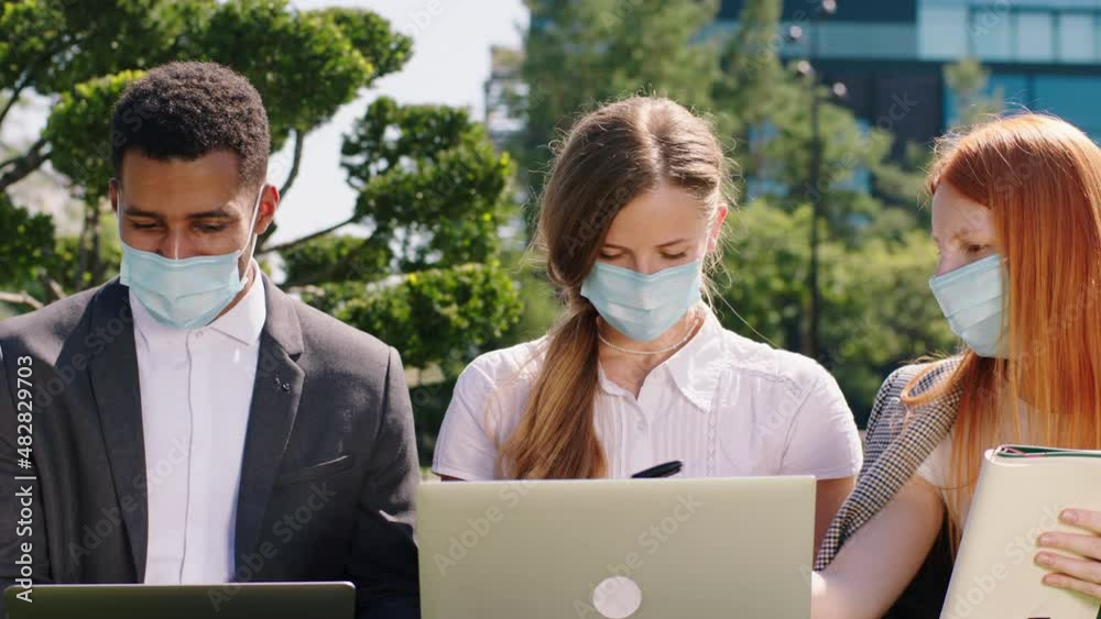 Charismatic group of multiracial students together after classes doing ...