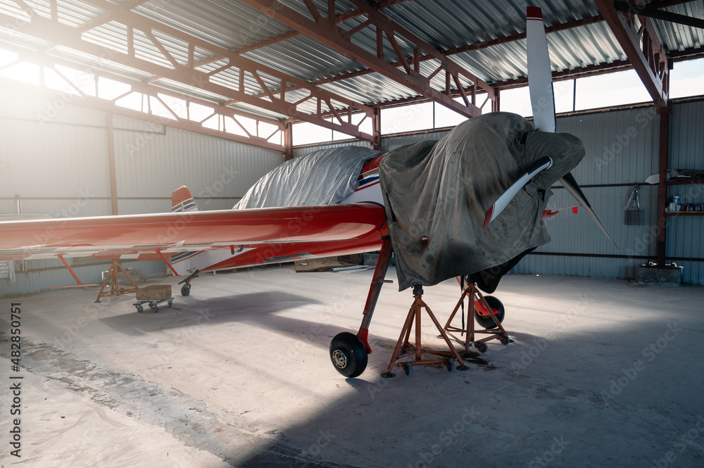 Small private lightweight propeller airplanes in hangar. Stock Photo ...