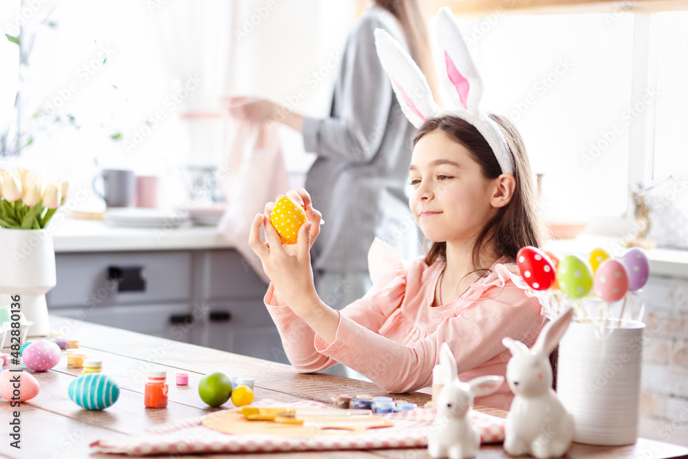 Beautiful cute girl with bunny ears having fun draw, paint, decorate ...