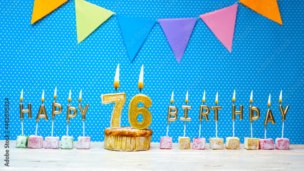 Foto de Happy birthday from number 76 candle letters on a blue ...