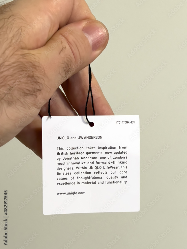 Paris, France - Jan 3, 2022: POV male hand holding sticker tag of a new ...