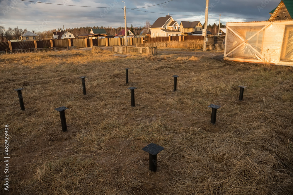 Pile foundation for the construction of a private house. Metal screw ...