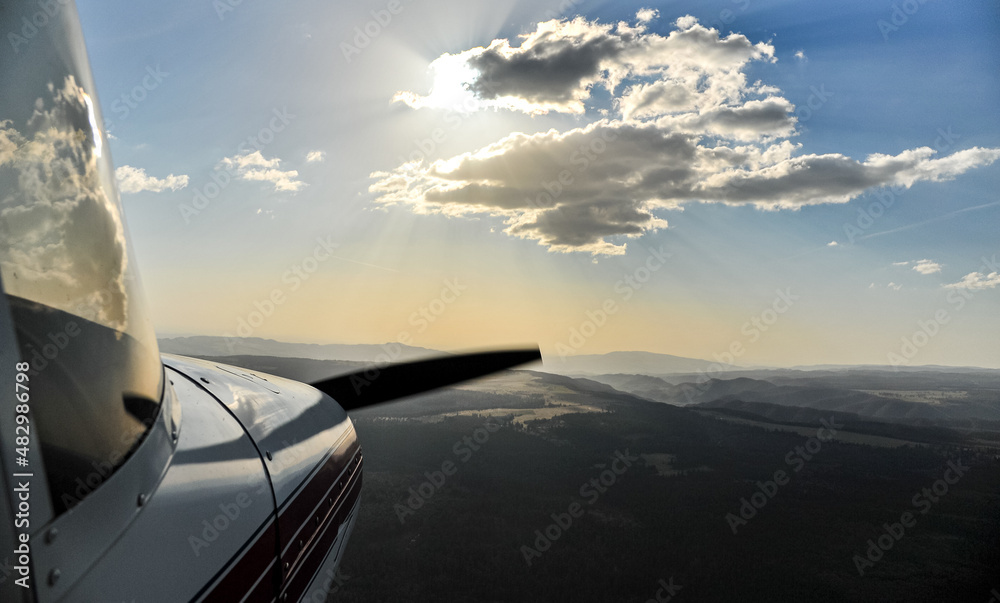 Flying a small airplane in a beautiful landscape with spectacular sky ...