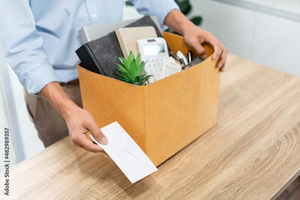 Resignation Concept The male officer standing, putting his box of his ...