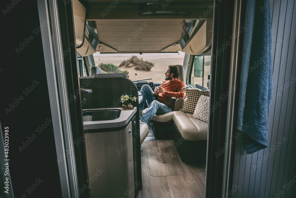 Adult man sitting inside van camper motorhome. Tourist of alternaive ...