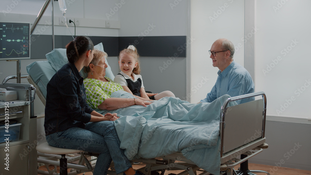 Niece hugging sick woman at family visit in hospital ward, child and ...