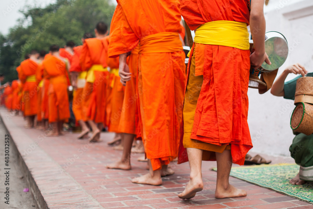 Buddhist monks during alms giving Stock Photo | Adobe Stock