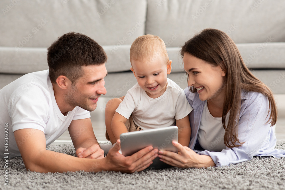 Baby Development Apps. Happy Family With Infant Child Using Digital ...