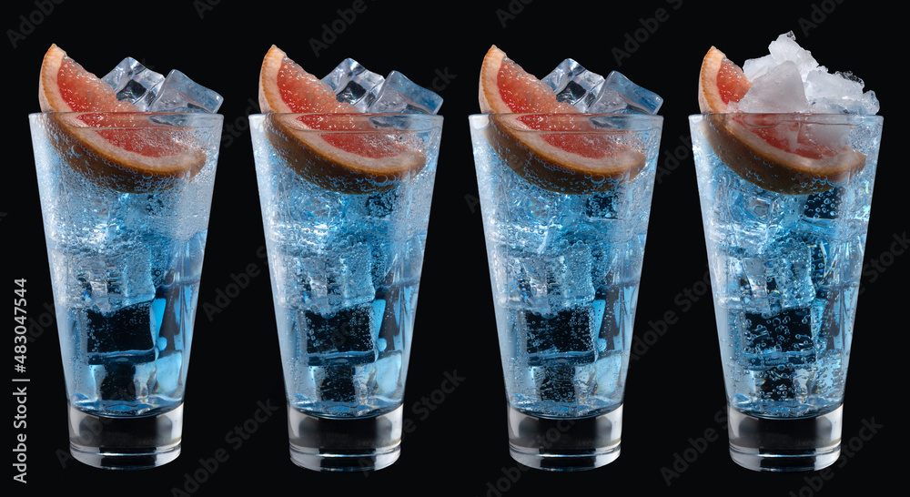 Blue lagoon cocktail with Blue Curacao liqueur in a tall glass isolated ...