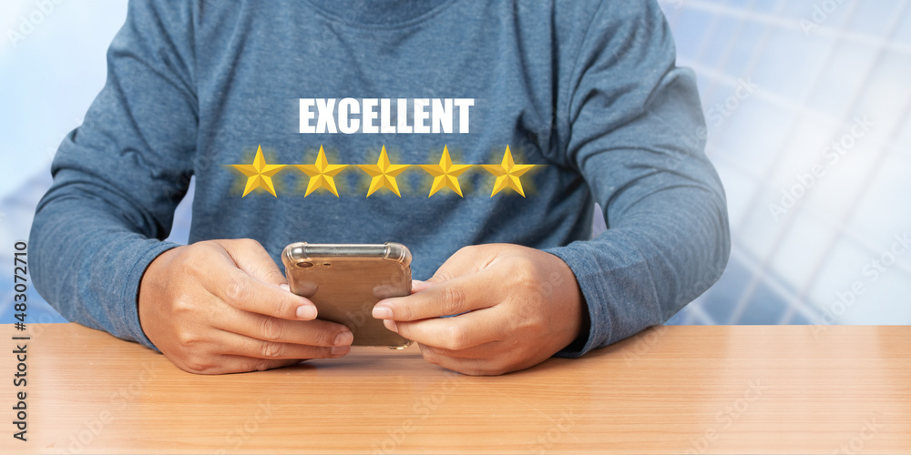 Man use smartphone choosing screen on five star icon to give ...