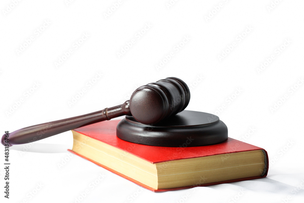 Abstract photo with wooden gavel and red book with codes isolated on ...