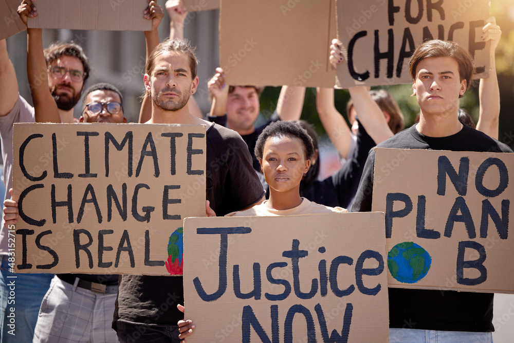We only have one planet. Shot of a group of people protesting climate ...