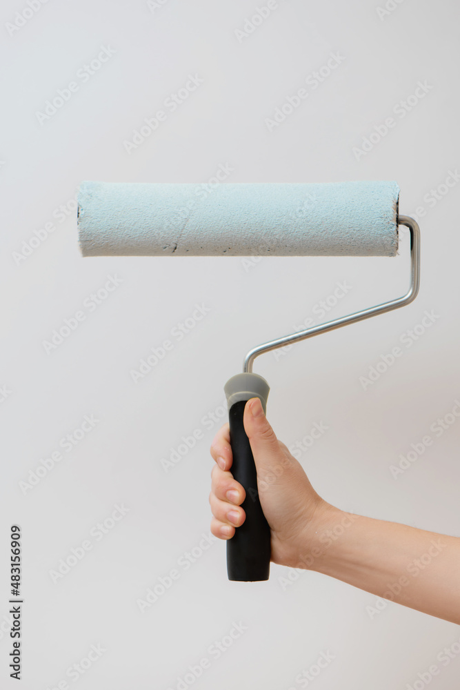 Hand holding paint roller isolated on white background. Stock Photo ...
