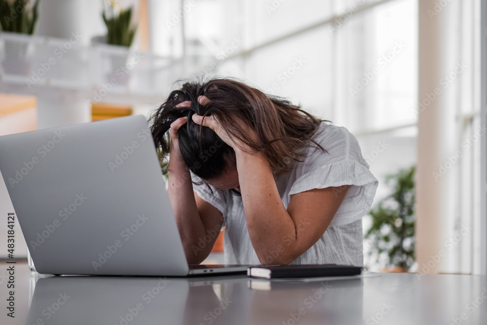 sad depressed remote working woman sitting disappointed with headache ...
