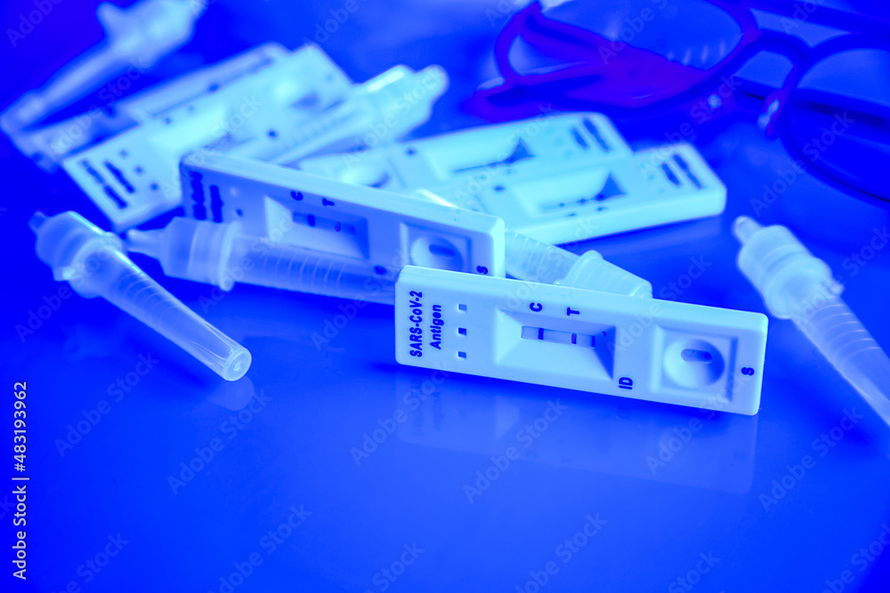 6 covid-19 antigen self-tests positive, buffer bottles and thin black ...