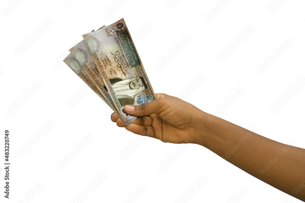 Fair hand holding 3D rendered Jordanian dinar notes isolated on white ...