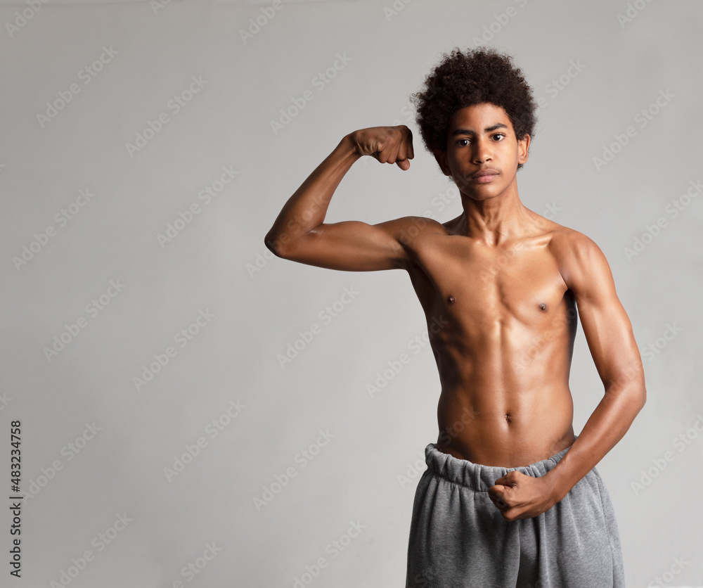 Strong Athletic handsome teenager afro Fitness Model Torso showing six ...
