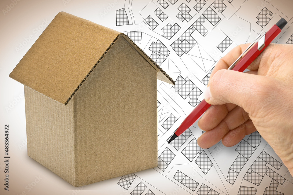 Architect drawing a residential building over an imaginary cadastral ...