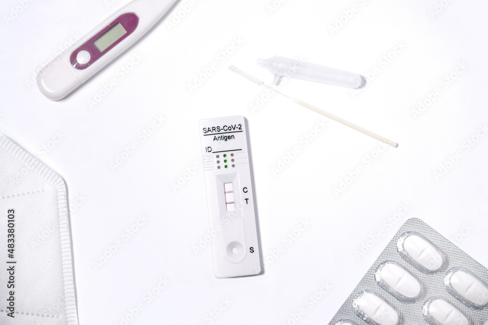 COVID-19 rapid antigen test positive result, thermometer and ...