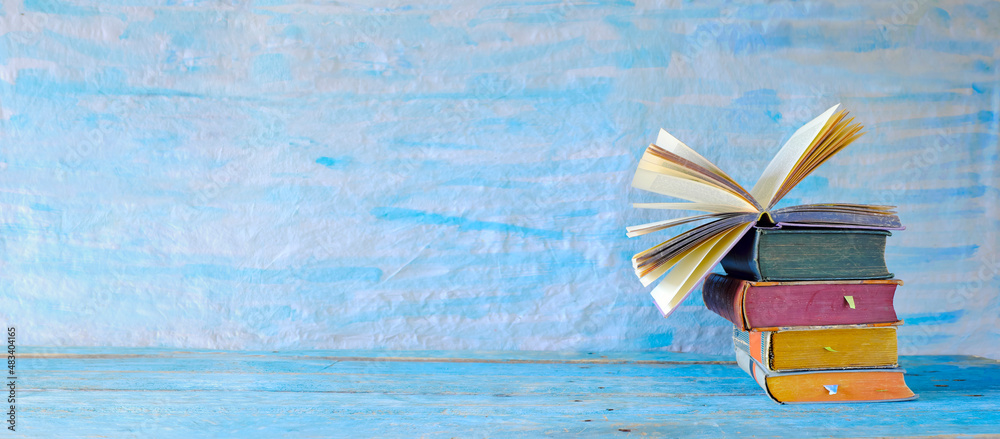 Open book on stack of hardback books. Back to school,education,reading ...