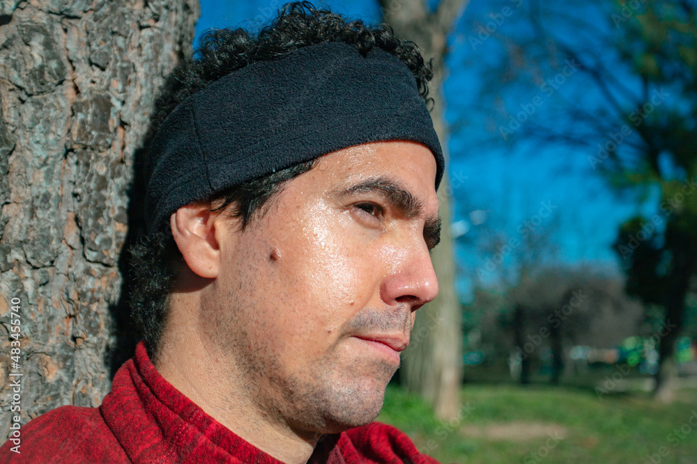Sport and mental health series lonely man sitting in a park on a sunny ...
