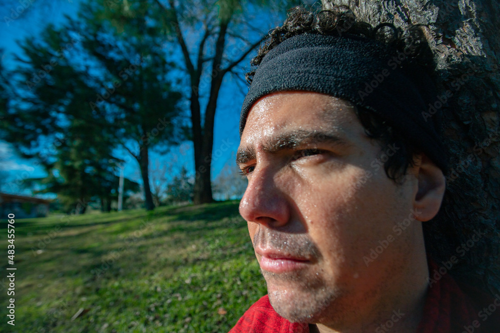 Sport and mental health series young man resting after running exercise ...