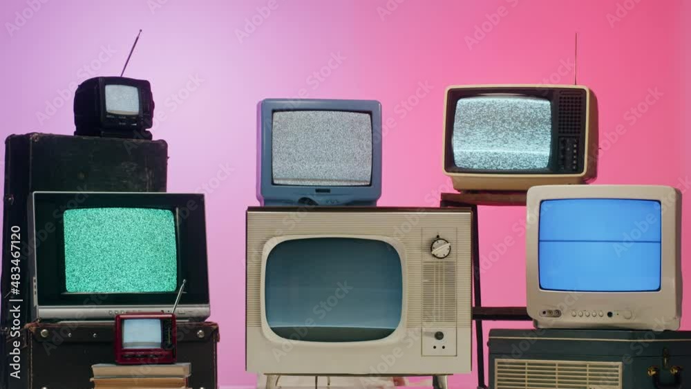 Old televisions with grey interference screen on pink red neon ...