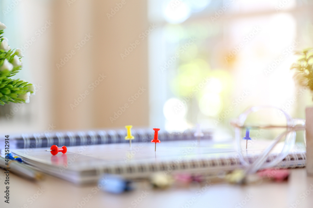Calendar, Close-up red pin on blank desk calendar with office equipment ...