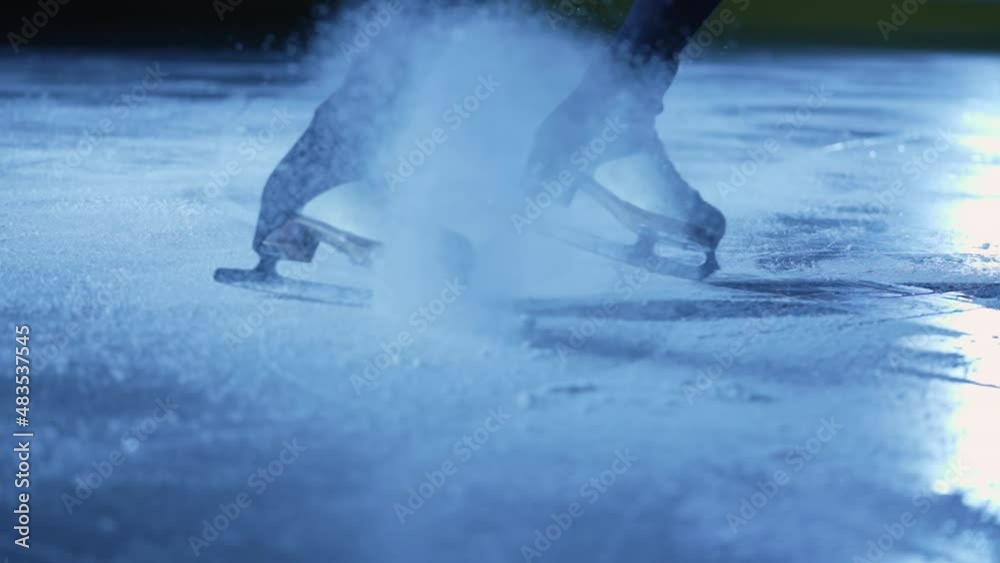 Detailed shot of women's legs in figure skating skates sliding on ice ...