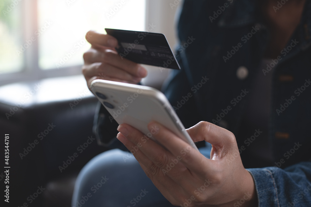 Young woman hands holding credit card, using smart mobile phone for ...