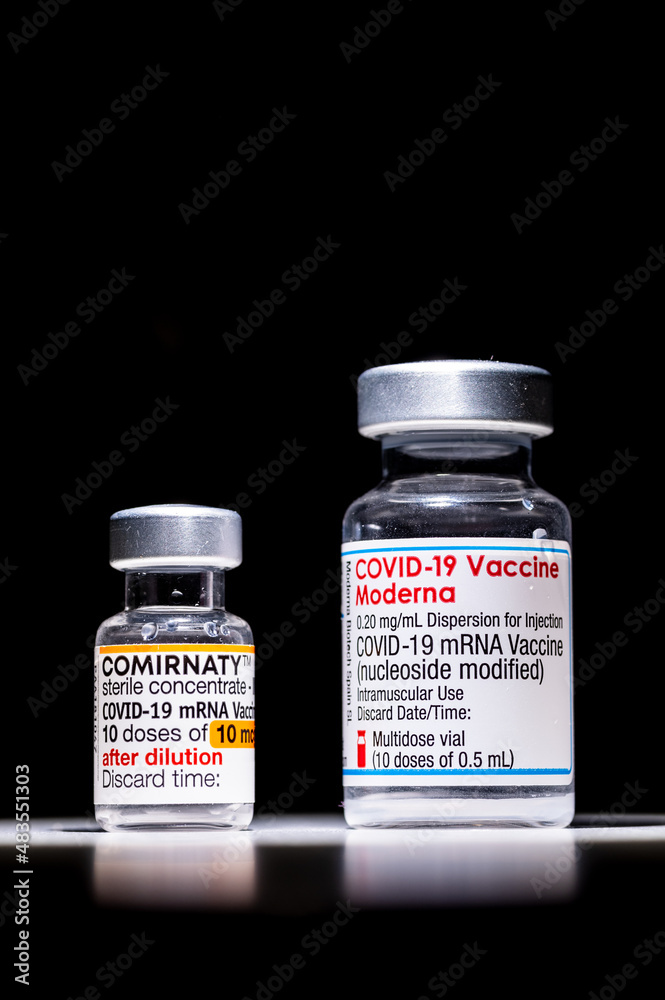 Vial of COMIRNATY (Pfizer BioNTech) and a vial of Moderna vaccines for ...