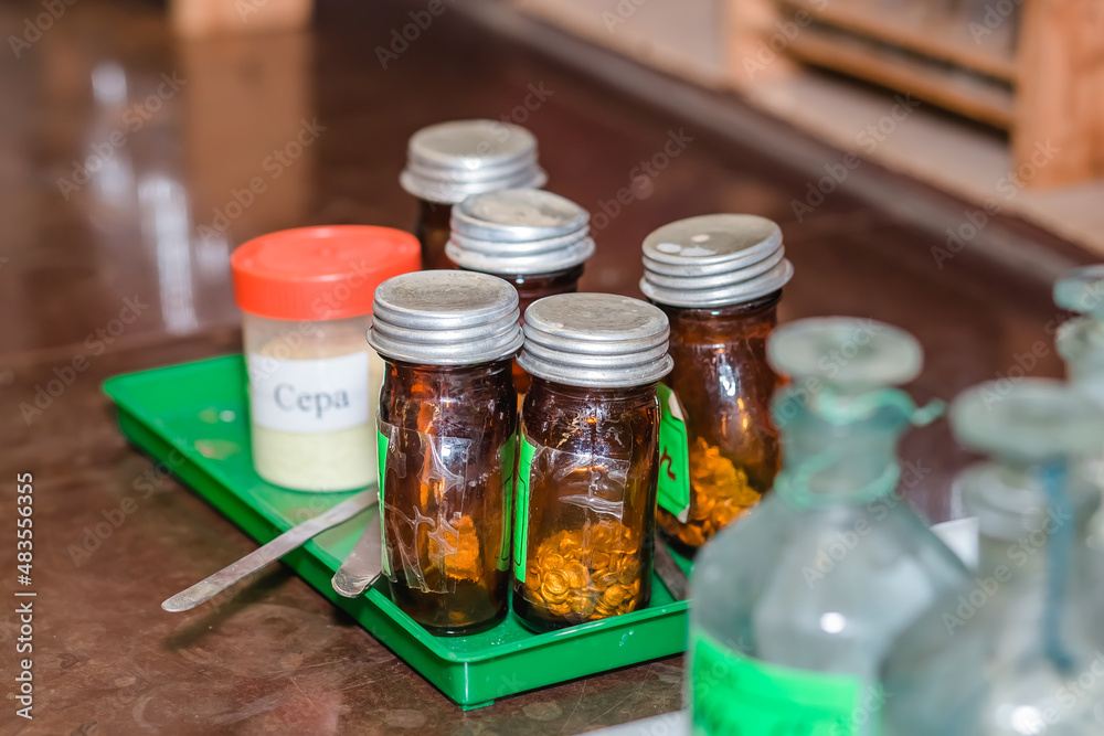 In the old chemical laboratory, jars of reagents are on a tray. Stock ...