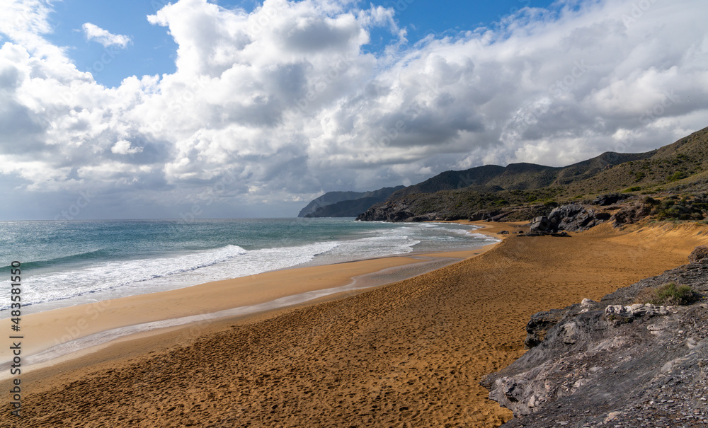 rocky ocean coast with mountains and a beautiful golden sand beach in ...