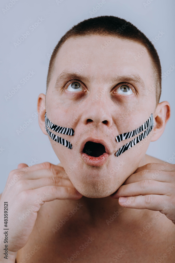Close-up of a guy's face with an anti-wrinkle cosmetic tape. Aesthetic ...