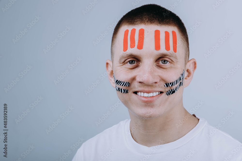 Close-up portrait of a guy looking at the camera with red patches on ...