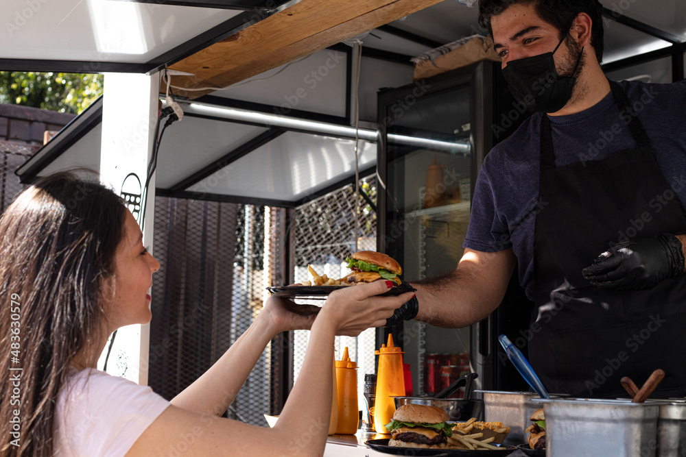 Food truck chef giving hamburger to customer Stock Photo | Adobe Stock