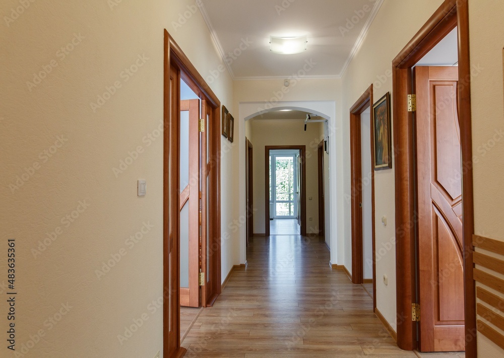 long corridor in a house with many open wooden doors. corridor in a ...