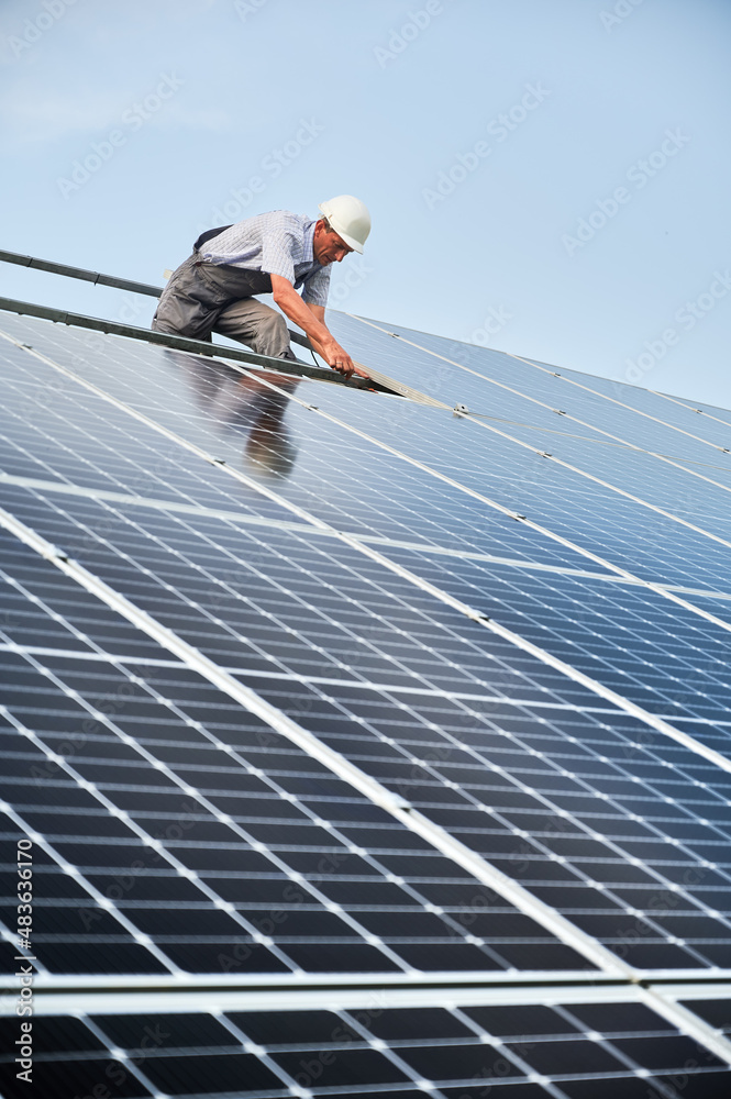 Male worker mounting photovoltaic solar panel system outdoors. Man ...